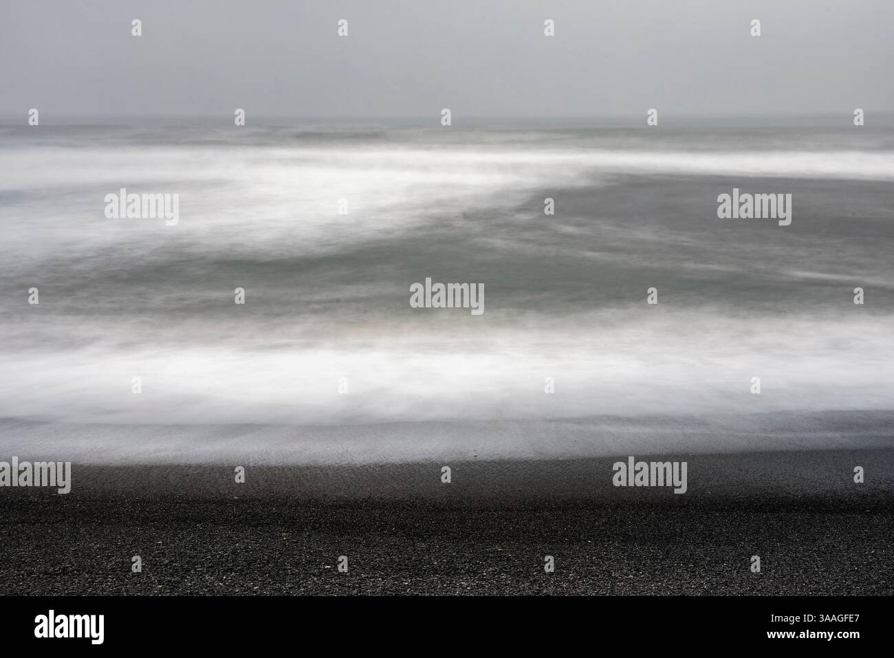 Long exposure of Pacific Ocean surf lapping up on Gold Bluffs Beach ...
