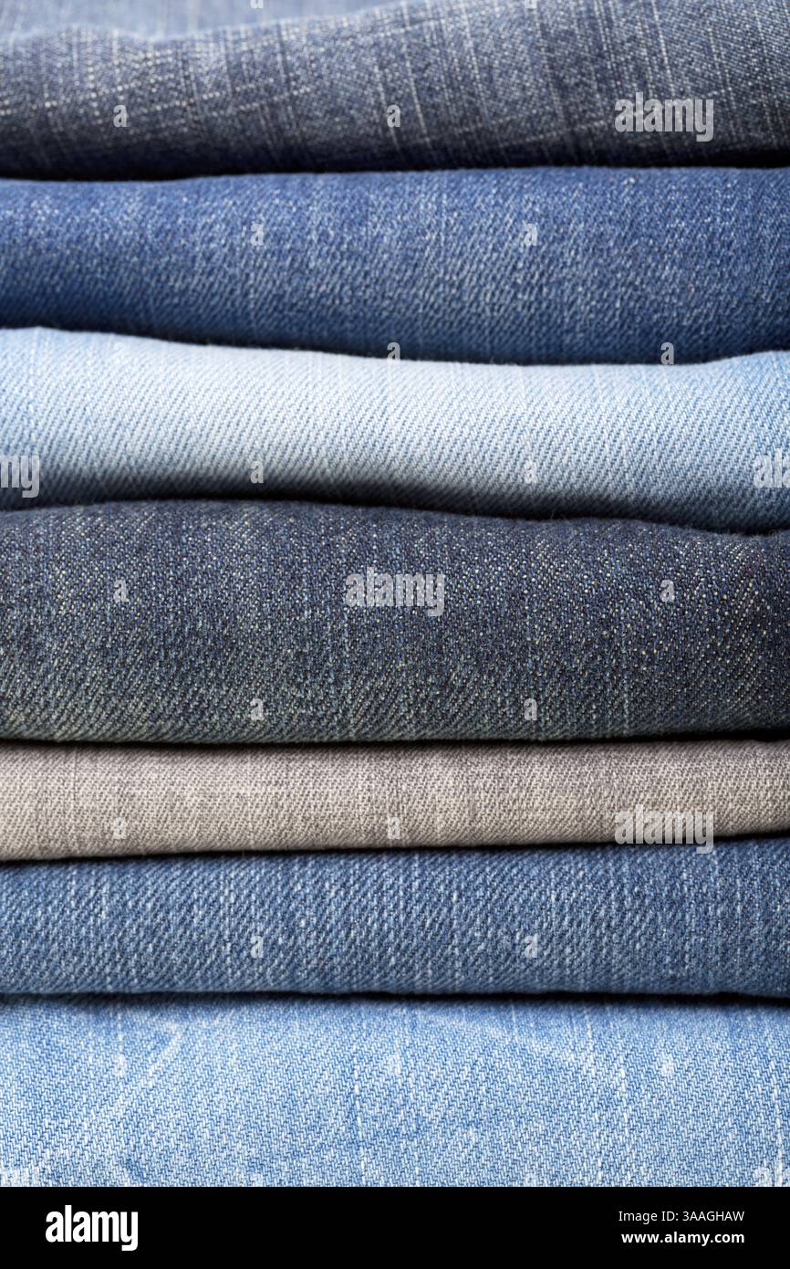 Stack of blue jeans background colors Stock Photo - Alamy