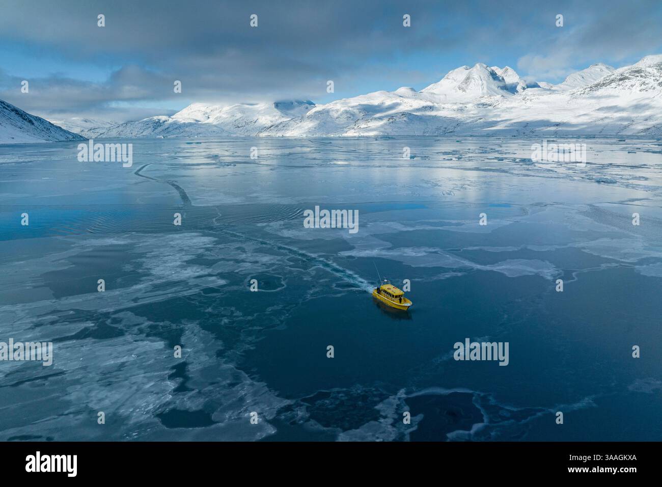 A boat rides through a frozen sea inlet outside of Nuuk, Greenland ...