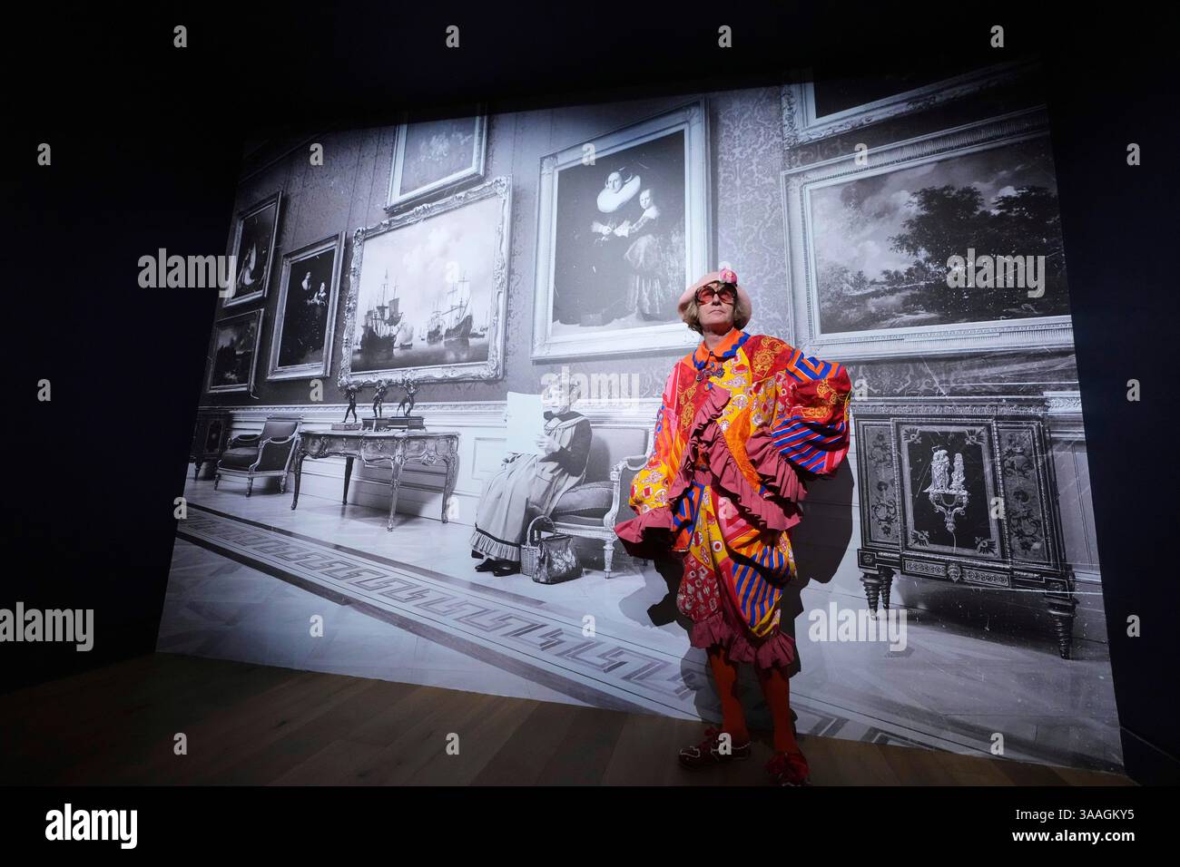 Artist Sir Grayson Perry poses in front of one of his pieces on display ...
