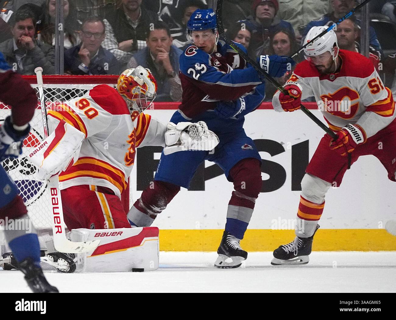 Calgary Flames goaltender Dan Vladar, left, stops a shot by Colorado ...
