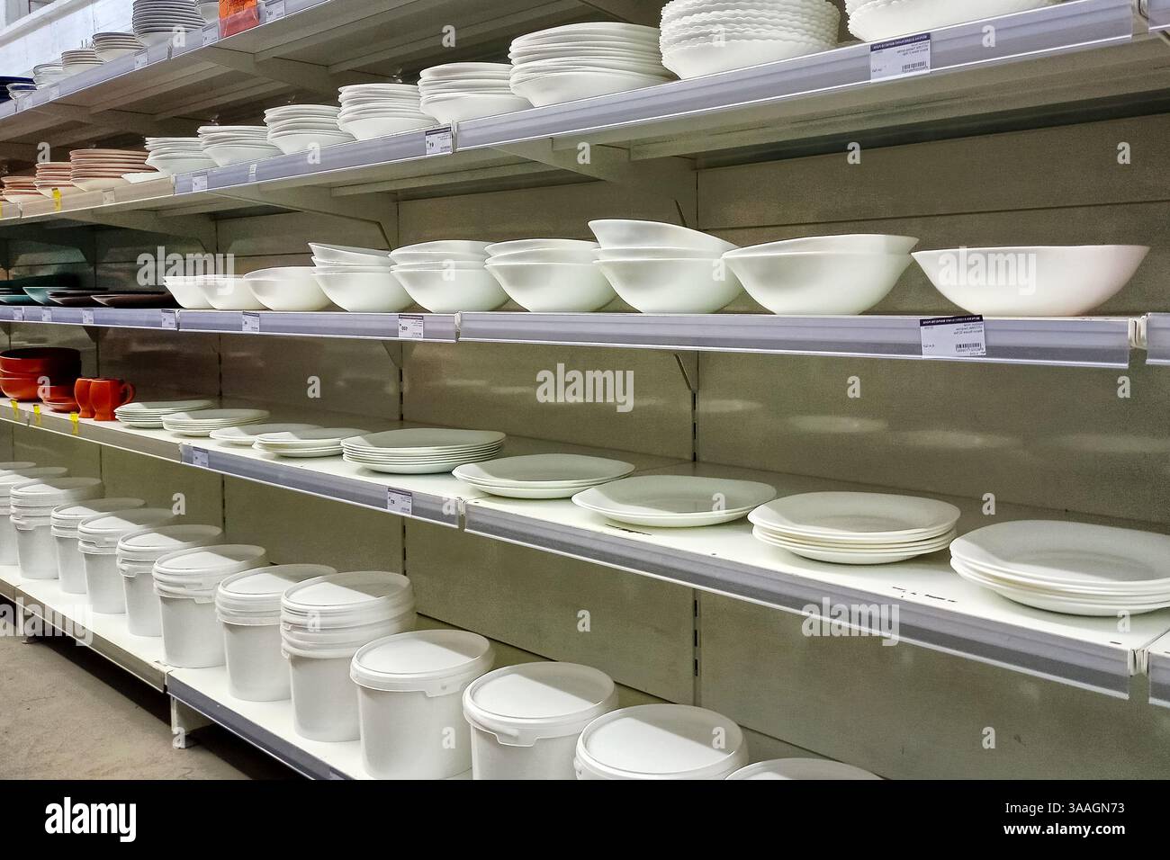 White dishes and containers are displayed in a well-organized fashion ...