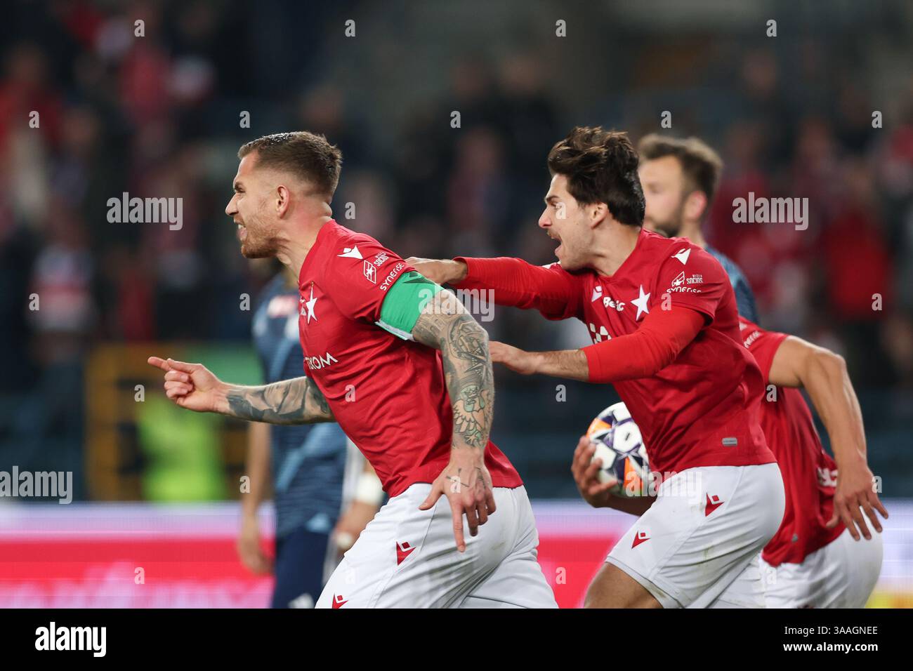 Krakow, Poland. 28th Mar, 2025. Alan Uryga of Wisla Krakow (L) and ...