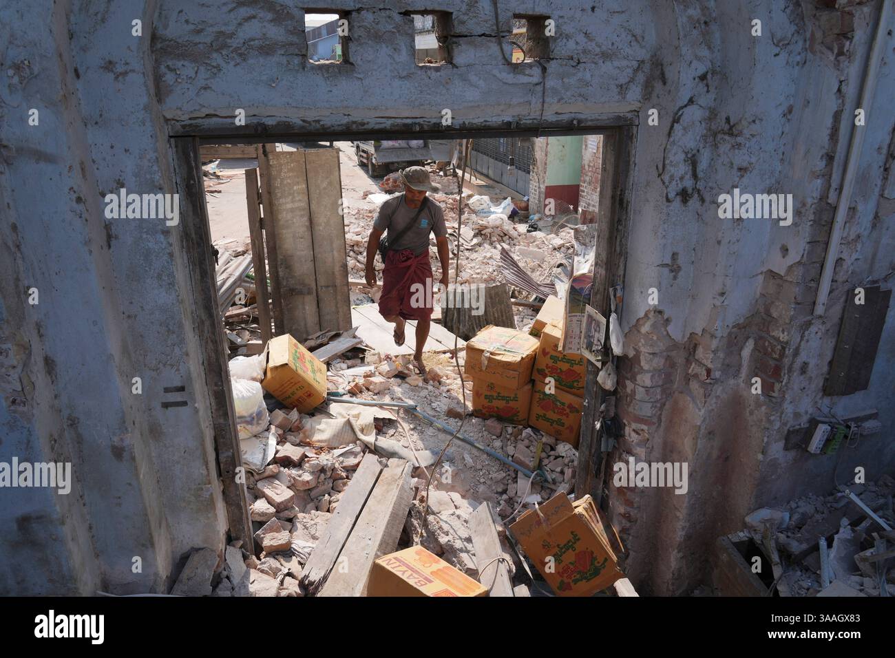 A man walks through a damaged building following Friday's earthquake in ...