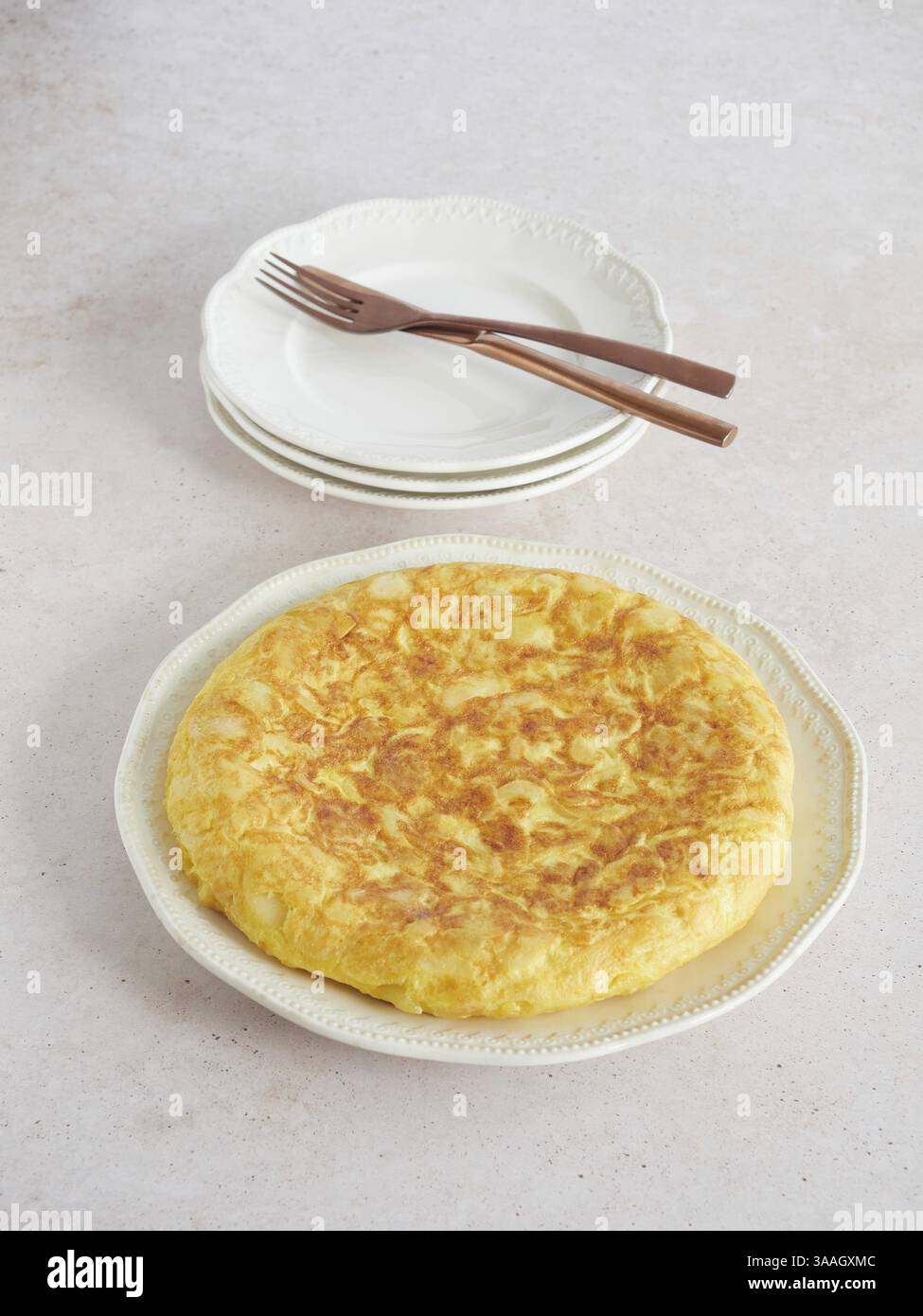 Round, golden brown spanish potato and egg whole omelet ready to eat ...