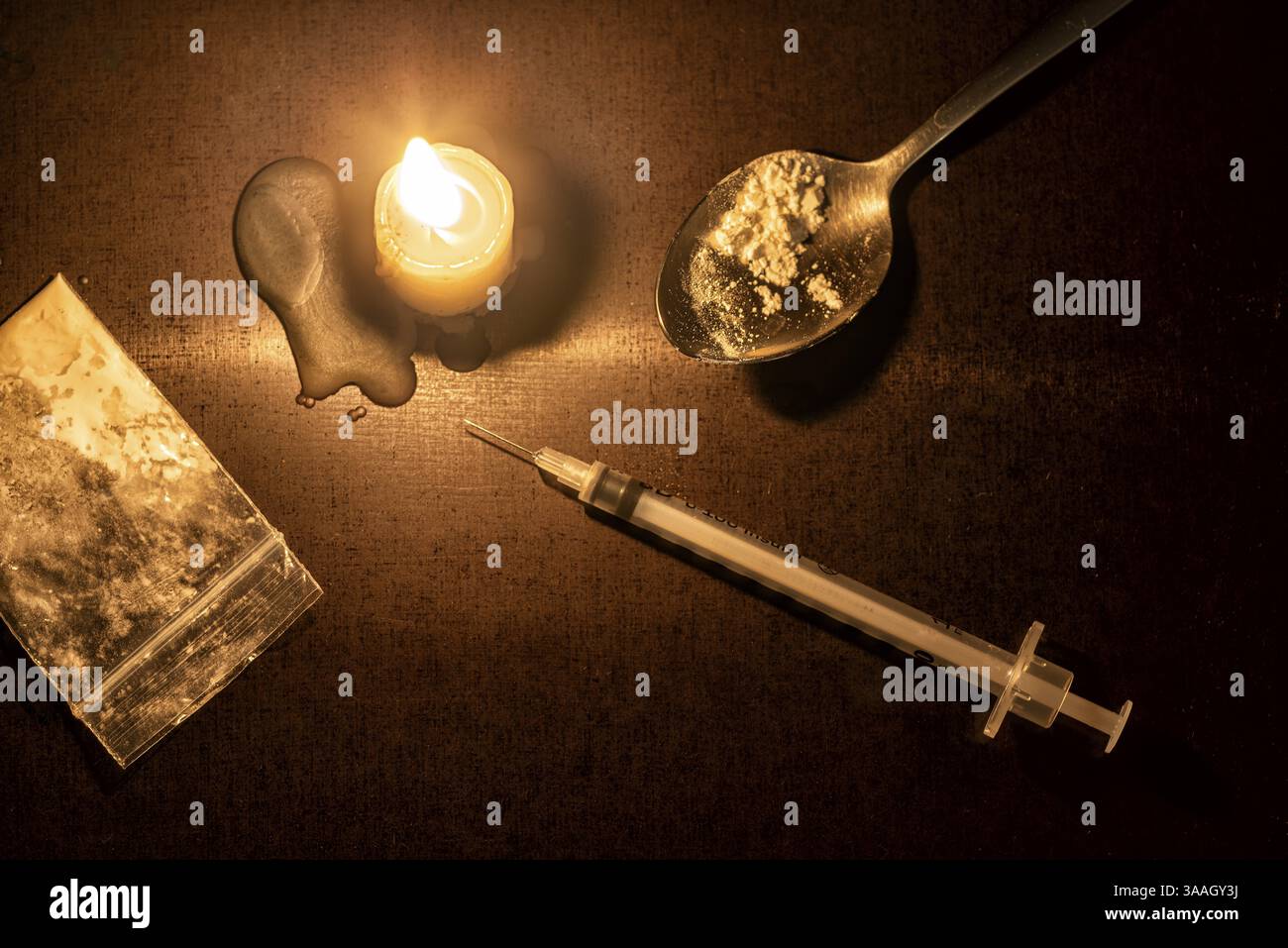 Injection, candle and heroine of a junkie Stock Photo - Alamy