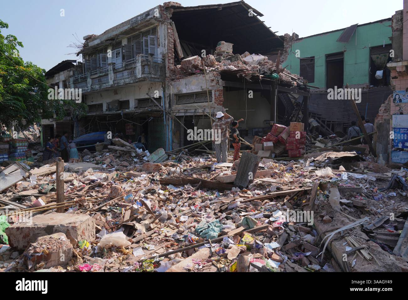 People inspect their homes, damaged following Friday's earthquake in ...