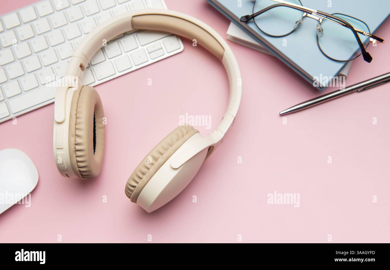 Modern workspace with wireless headphones, keyboard, computer mouse ...