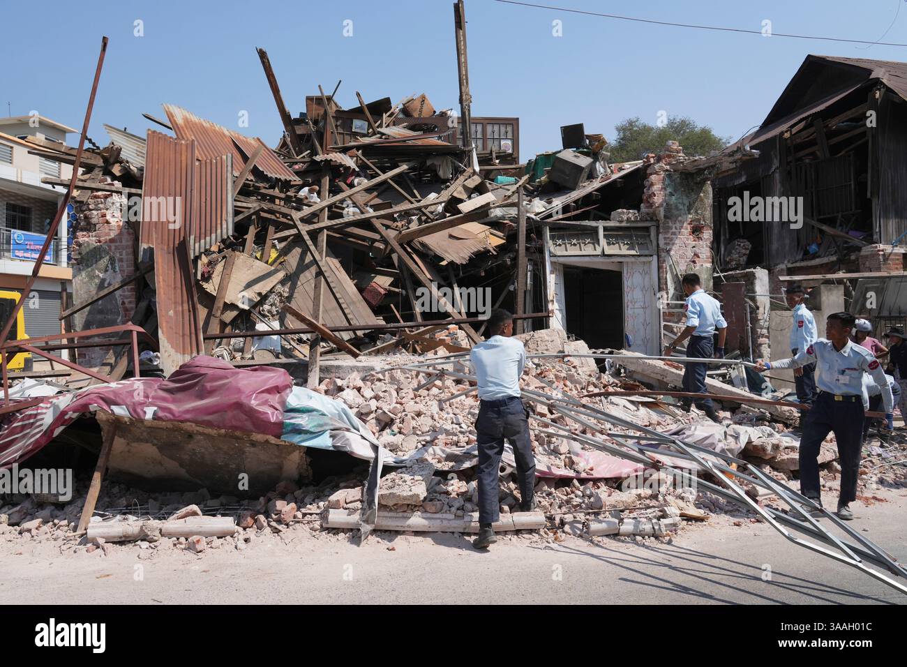 Myanmar's military rescuers work through rubble of a collapsed building ...