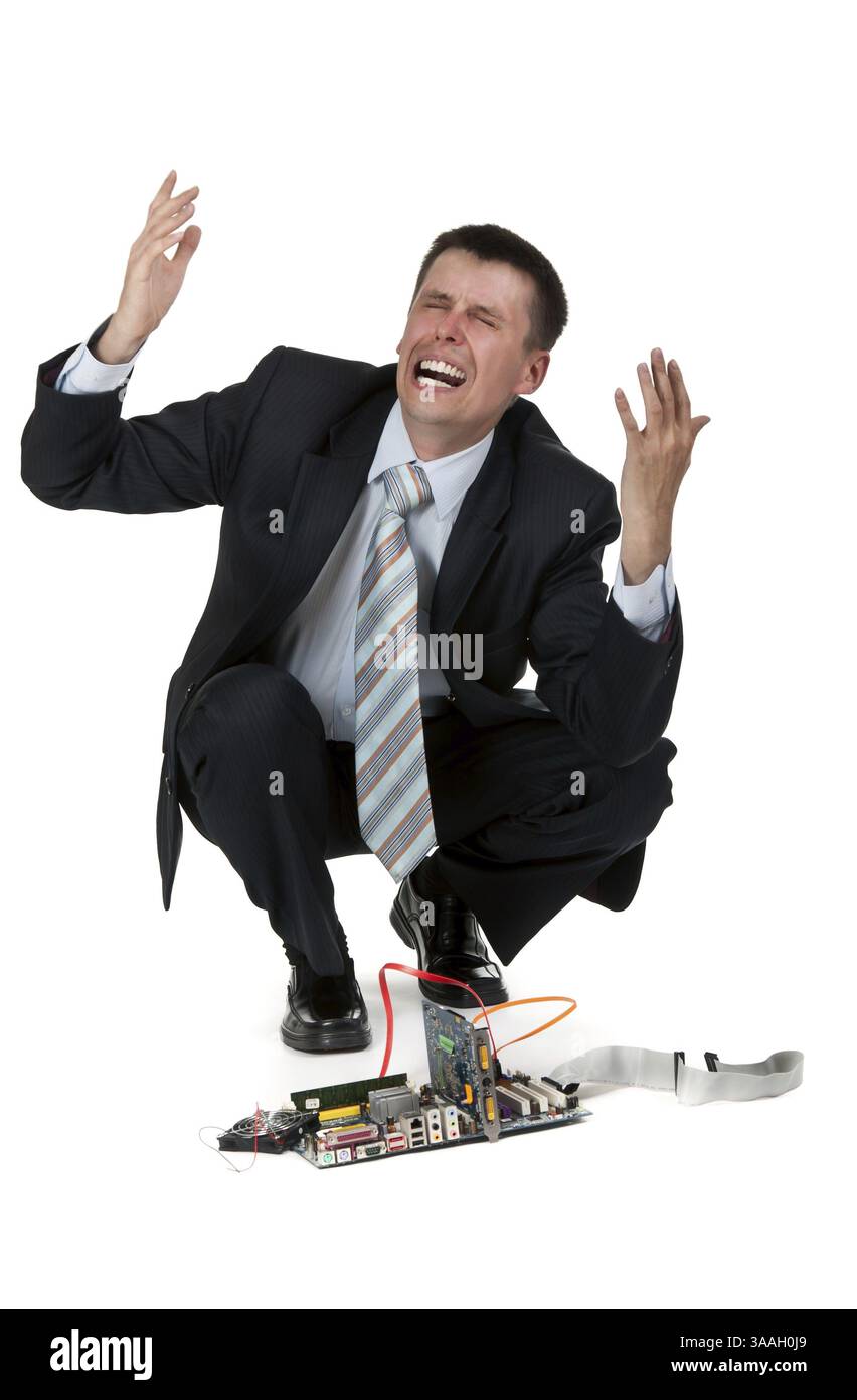 Businessman is crying over the broken computer on a white background ...
