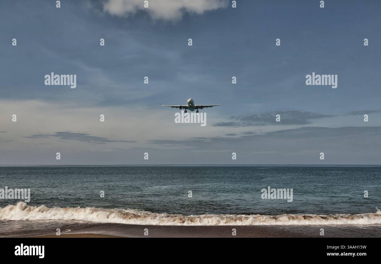 Passenger plane landing approach over a tropical beach Stock Photo - Alamy