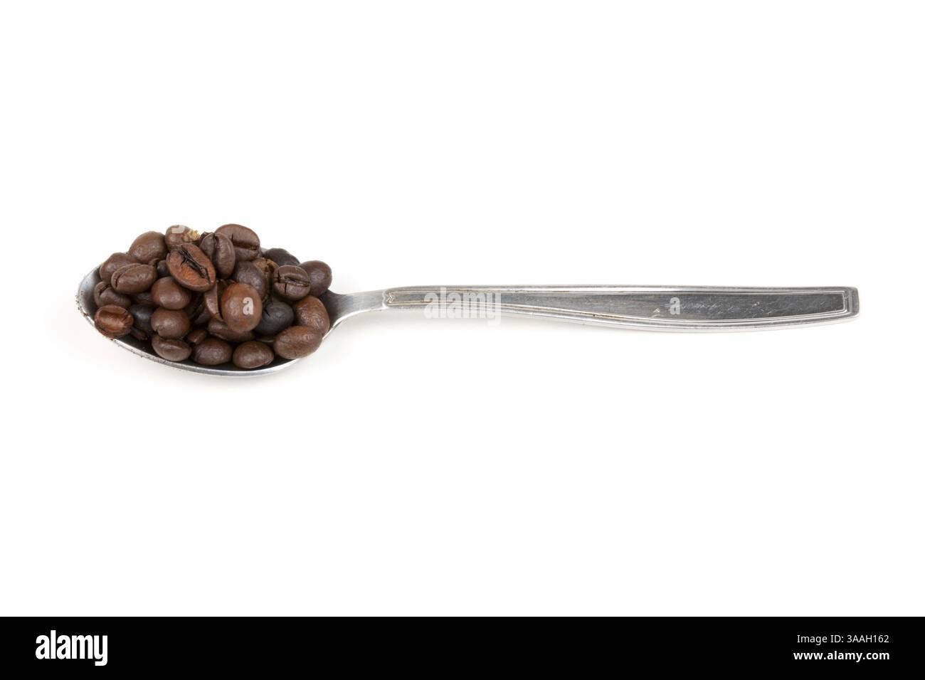 Spoon with coffee beans isolated on white background Stock Photo - Alamy