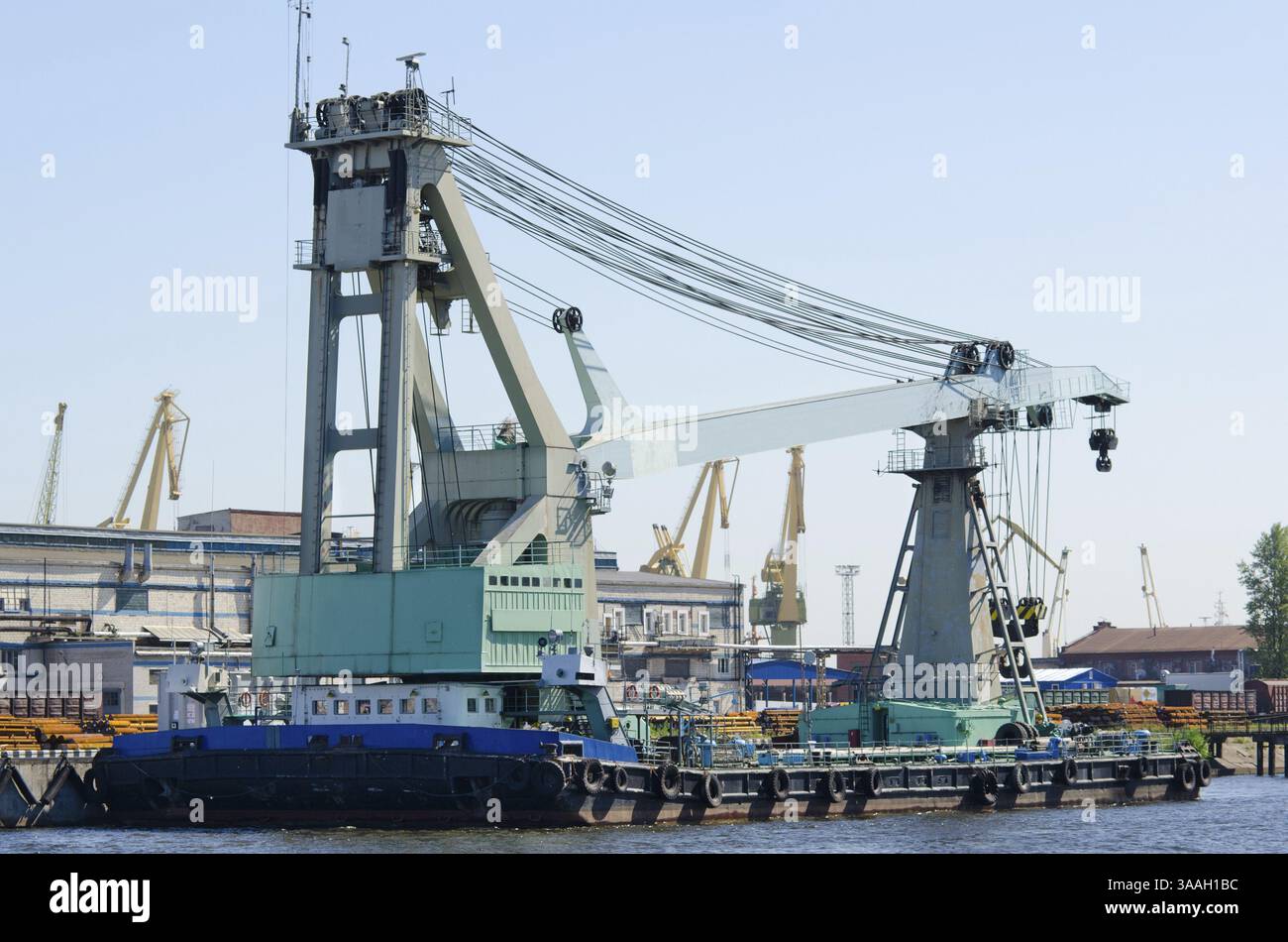 A huge floating crane by a river wharf Stock Photo - Alamy