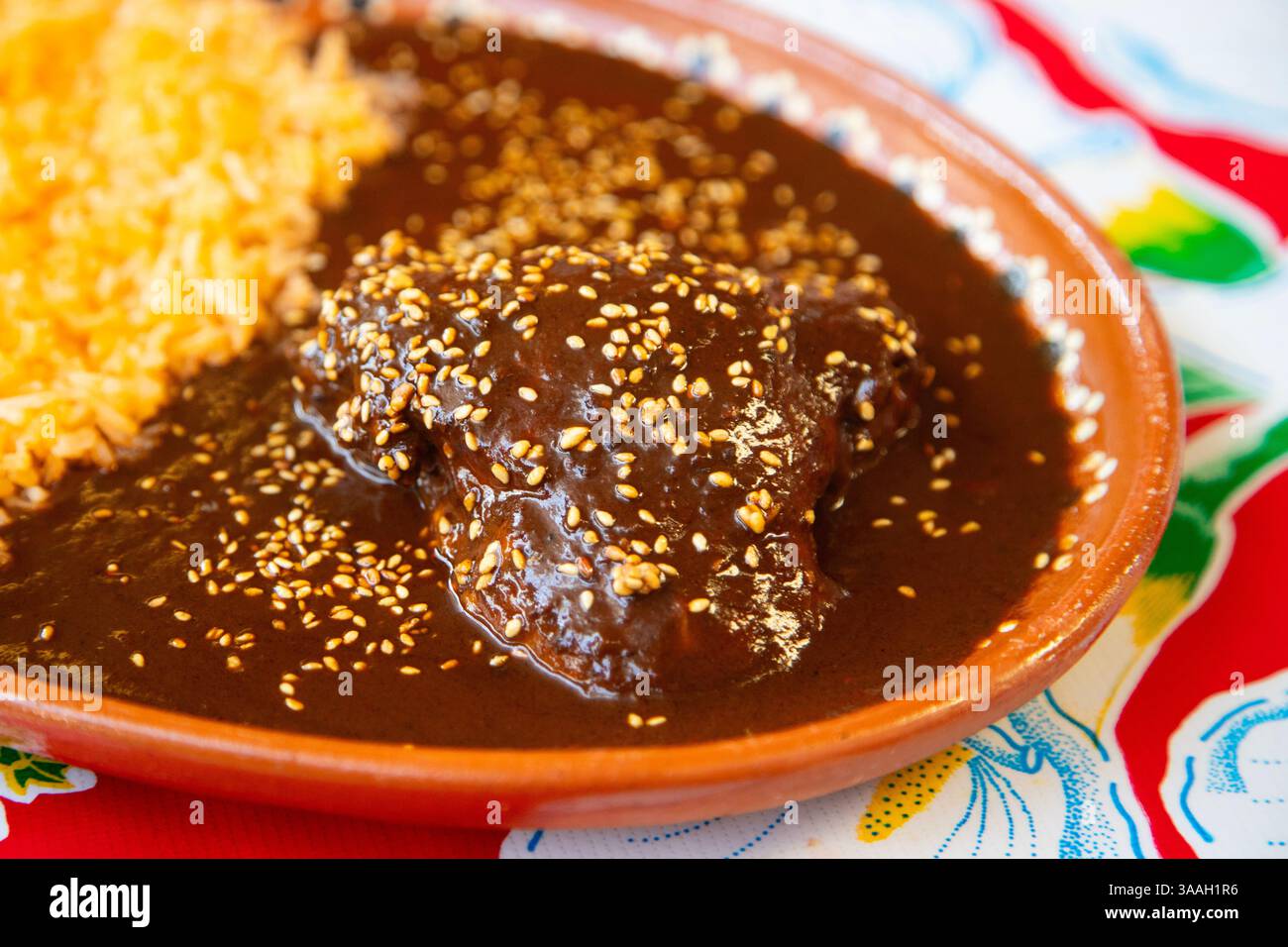 A traditional clay pottery dish with mole and chicken from Puebla, a ...