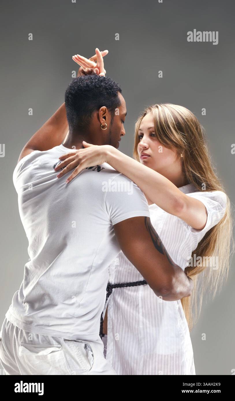 Young couple dances Caribbean Salsa, studio shot Stock Photo - Alamy