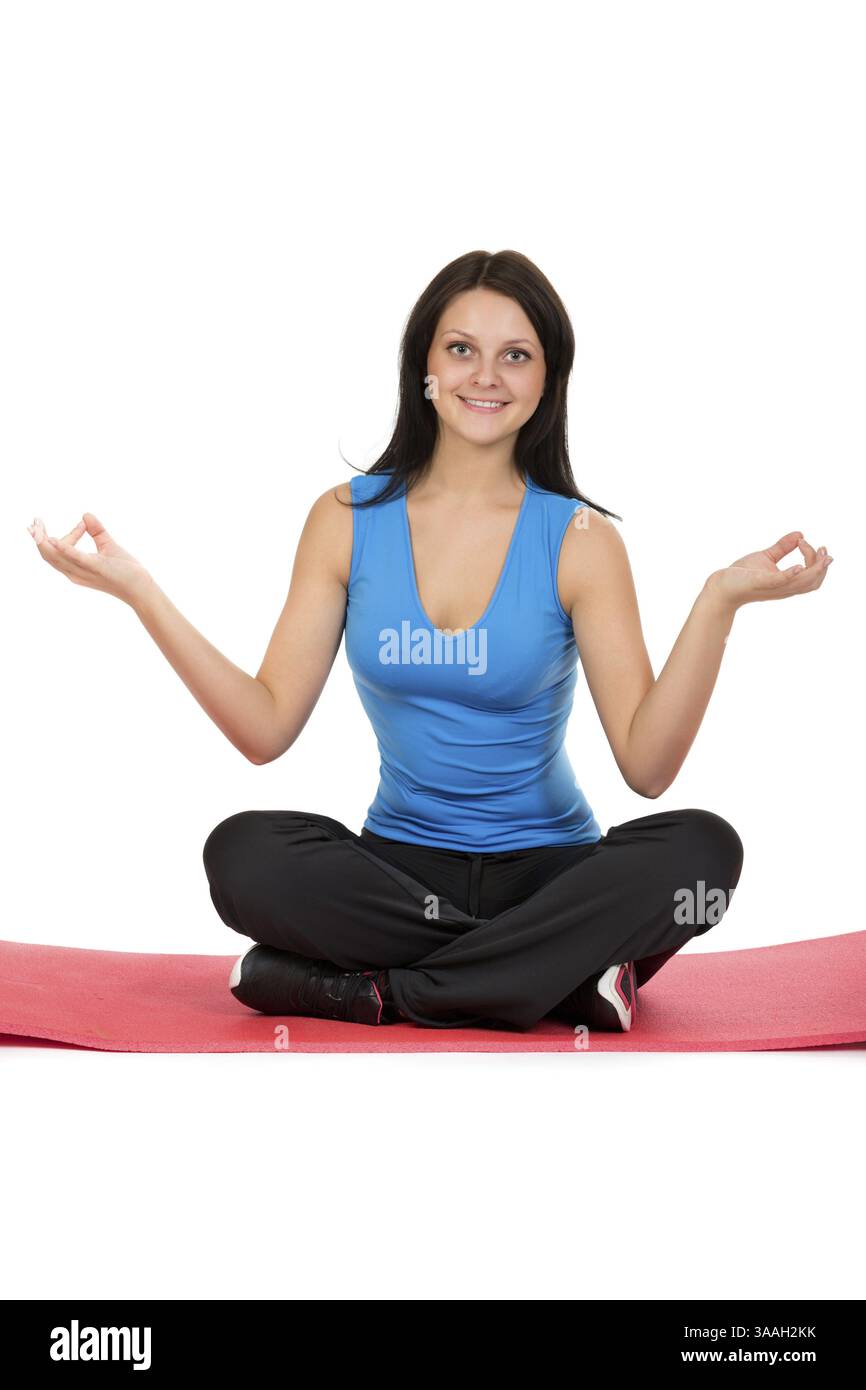 Beautiful girl meditating in the lotus position Stock Photo - Alamy