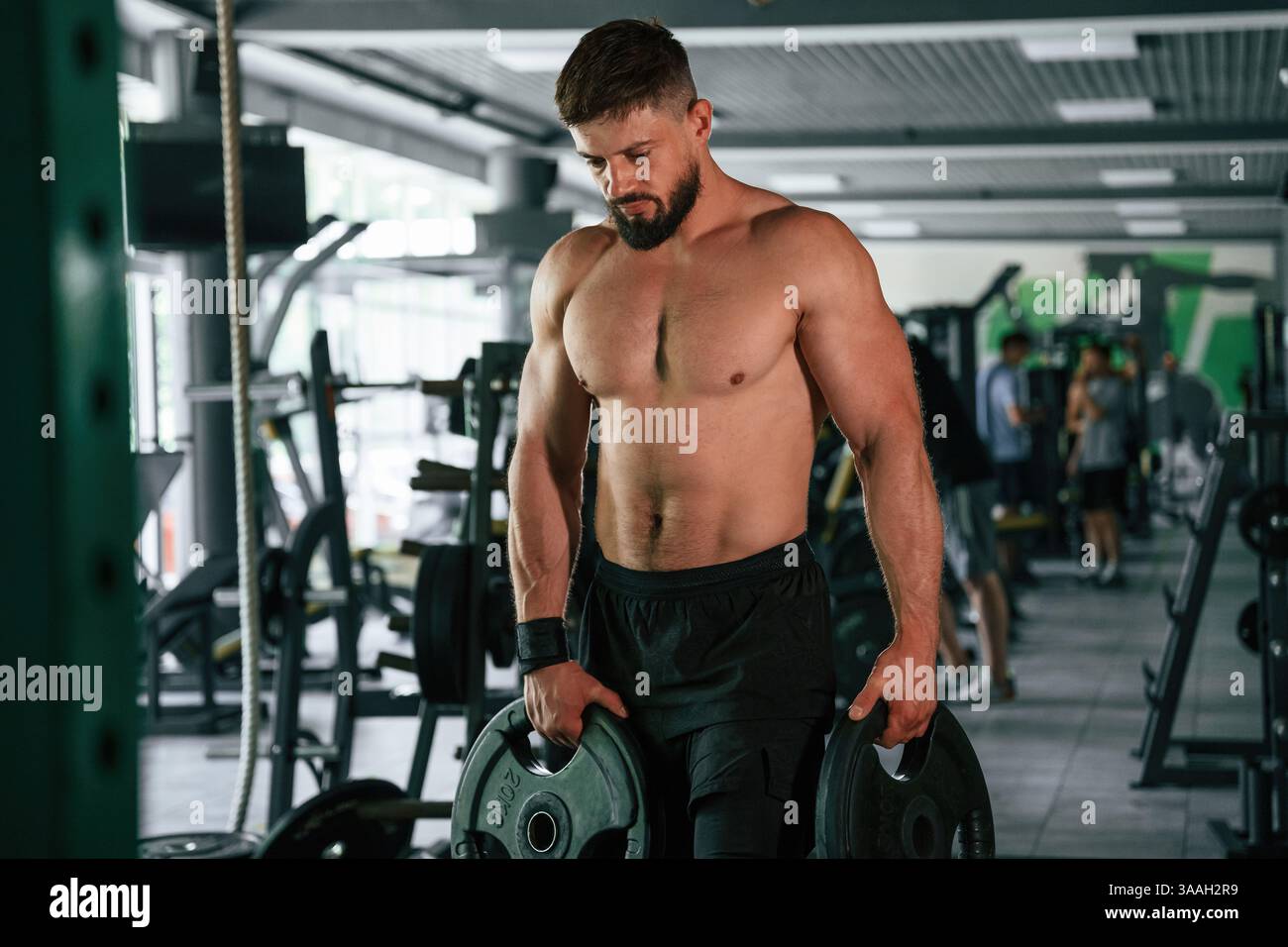 Muscular strong man is working out in the gym Stock Photo - Alamy