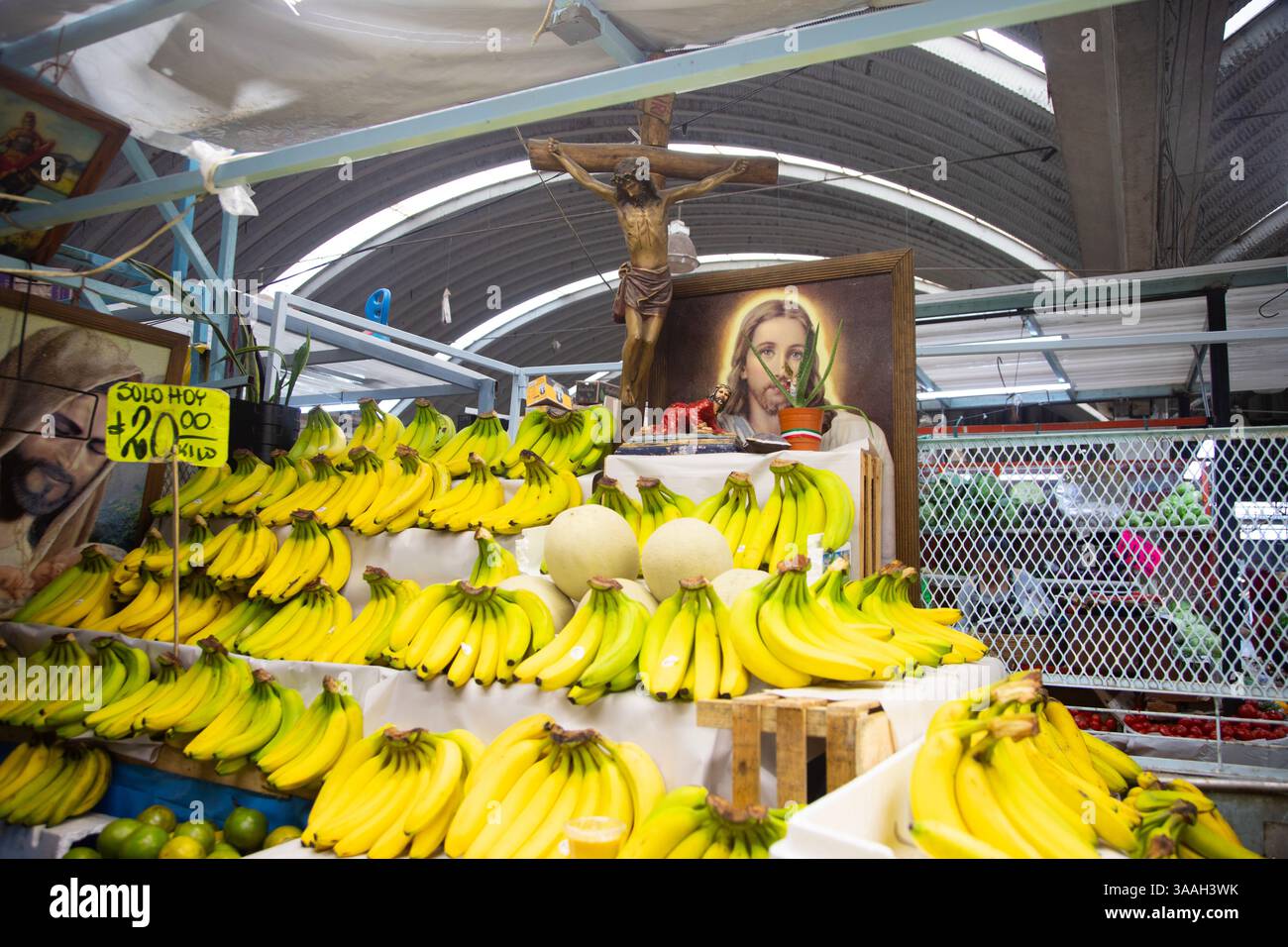 A fruit stand with bananas and a religious photo in a market in the ...