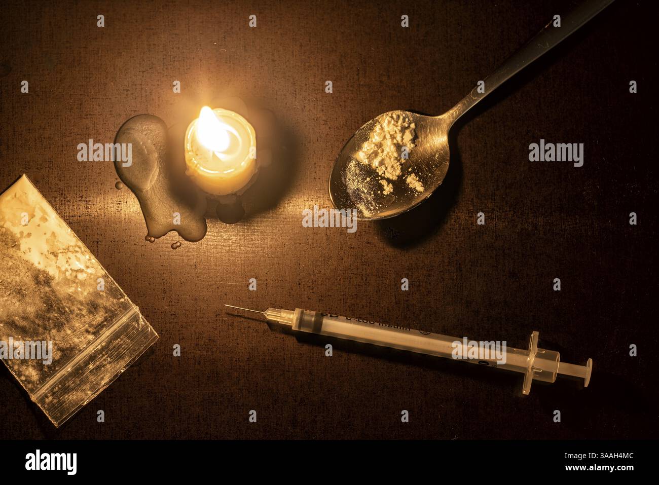 Injection, candle and heroine of a junkie Stock Photo - Alamy