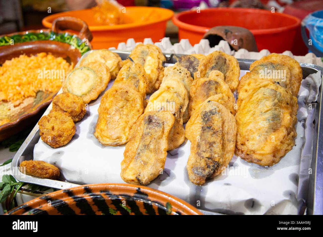 Traditional food stall with moles, nopales, and chiles in clay pots at ...