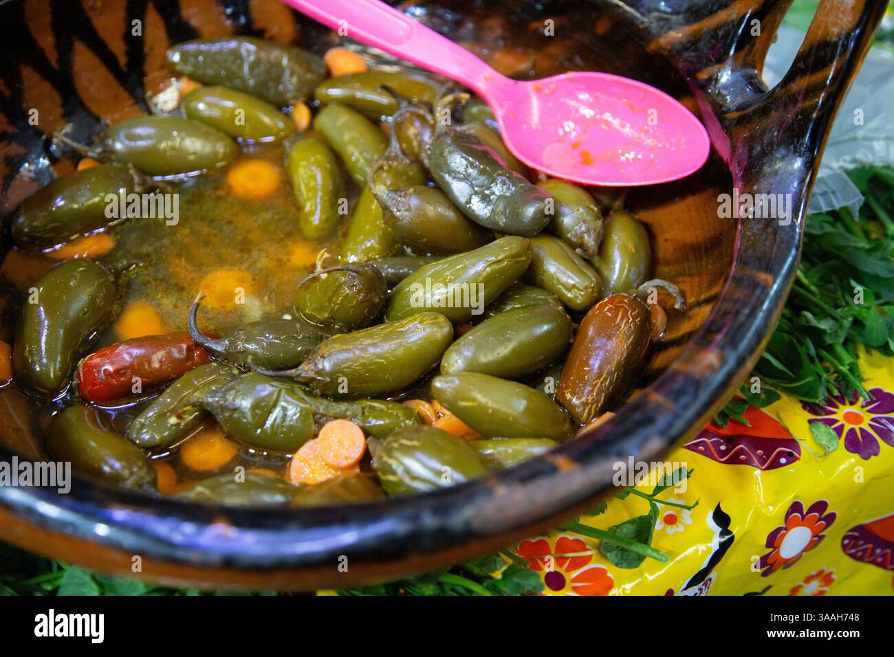 Traditional food stall with moles, nopales, and chiles in clay pots at ...