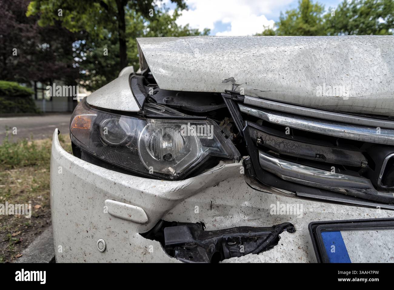 Badly damaged car on the side of the road after an accident Stock Photo ...