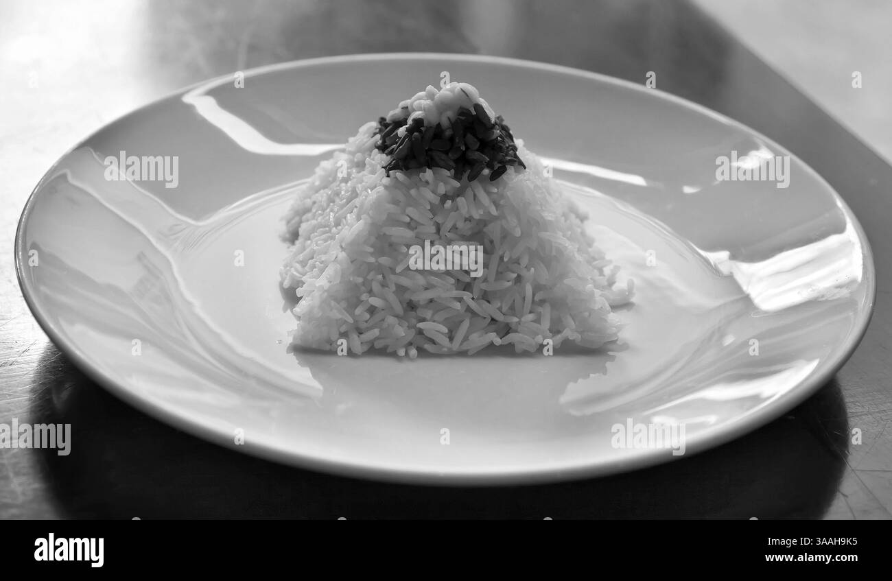 Pyramid of rice on a plate in a restaurant with a worn table Stock ...