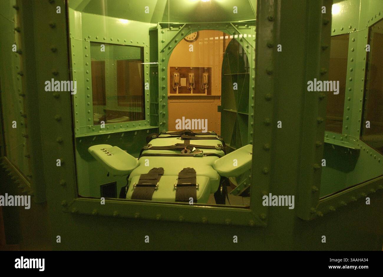 The phones to stop an execution hang on the wall in the background near ...