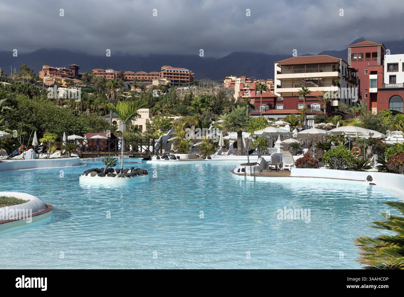 Hotel swimming pool against the backdrop of volcanic mountains with a ...
