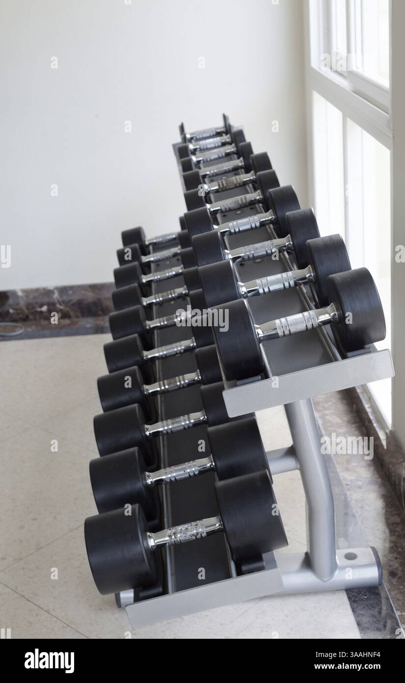 Set of different dumbbell rack Stock Photo - Alamy