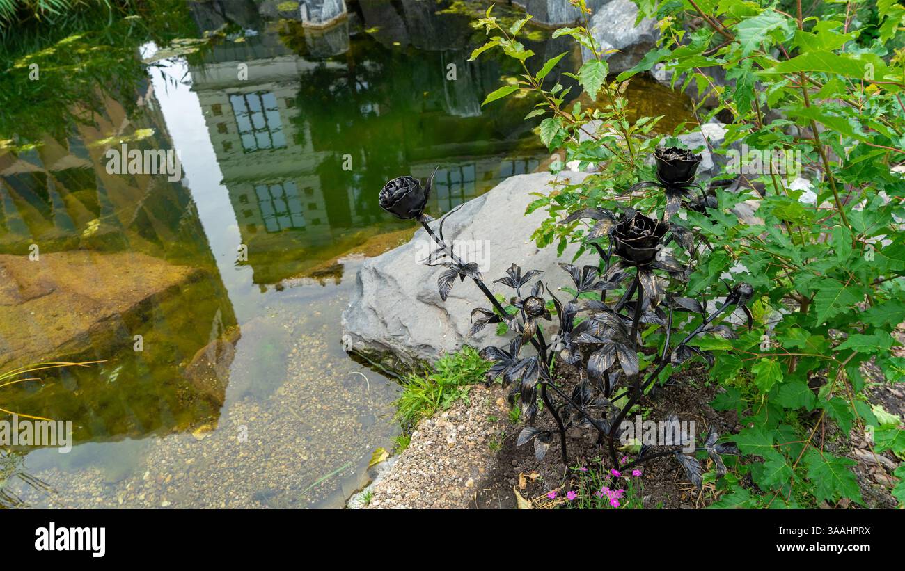 Forged metal roses in park by pond on embankment of Iset River ...