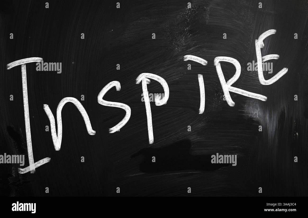 Inspire handwritten with white chalk on a blackboard Stock Photo - Alamy