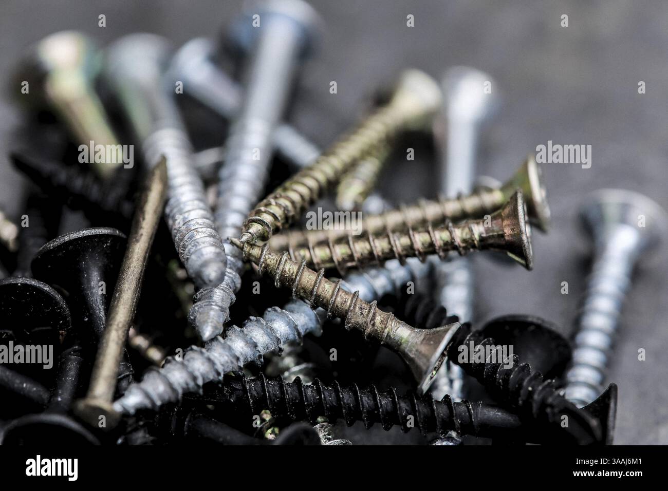 Different Kind of Screws on a table in a workshop Stock Photo - Alamy
