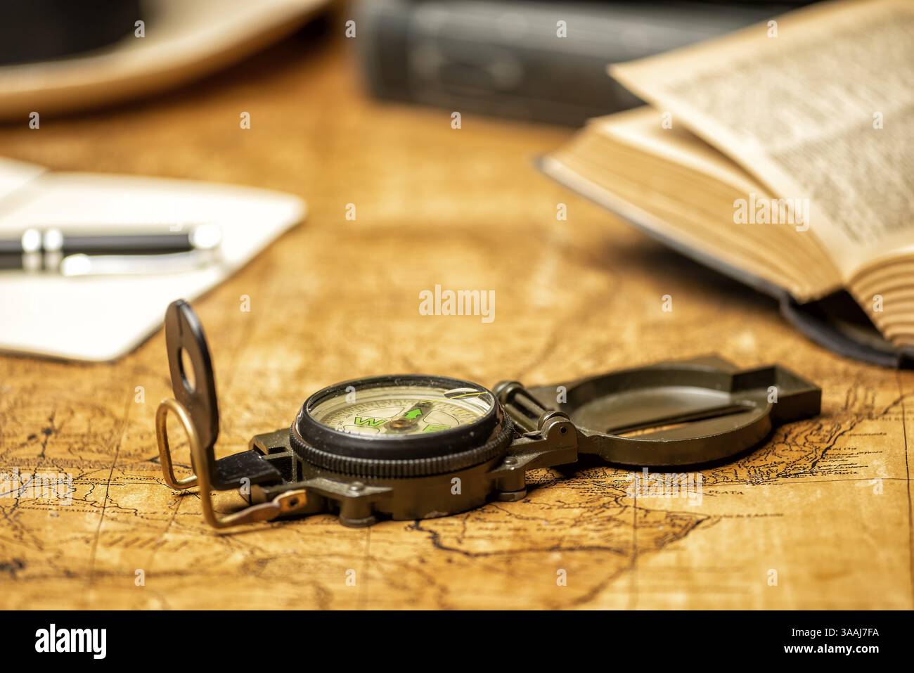 Old expedition map with compass, notebook, books and Panama hat Stock ...