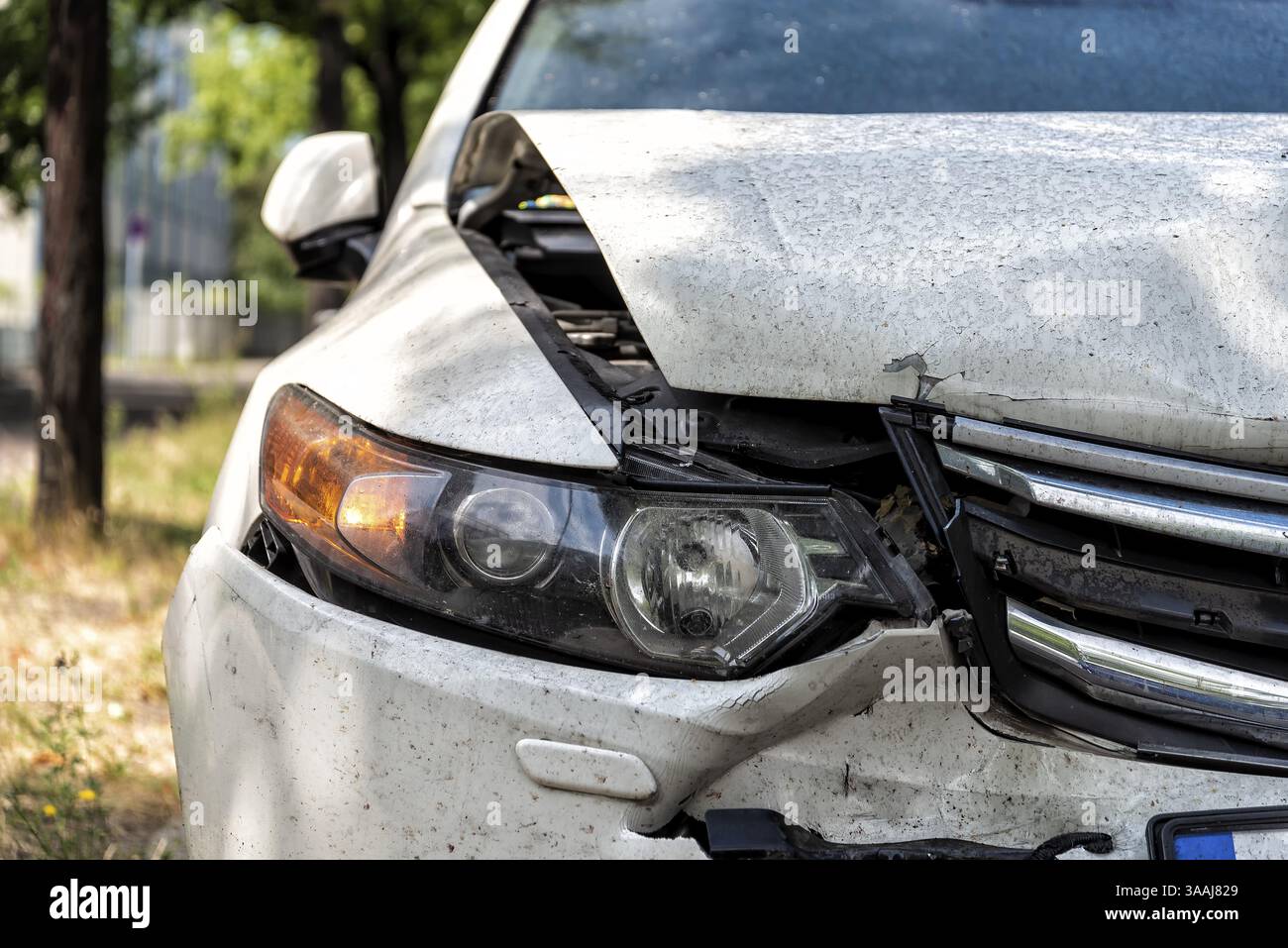 Badly damaged car on the side of the road after an accident Stock Photo ...