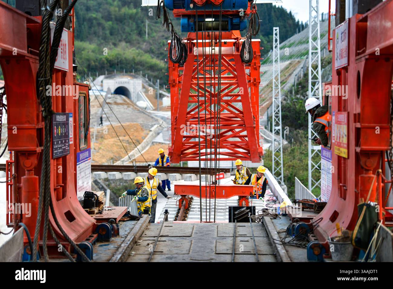 Fuquan. 31st Mar, 2025. Workers lay tracks at the construction site of ...
