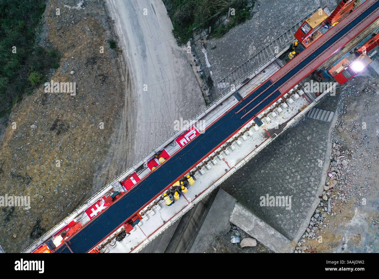Fuquan. 31st Mar, 2025. An aerial drone photo shows workers laying ...