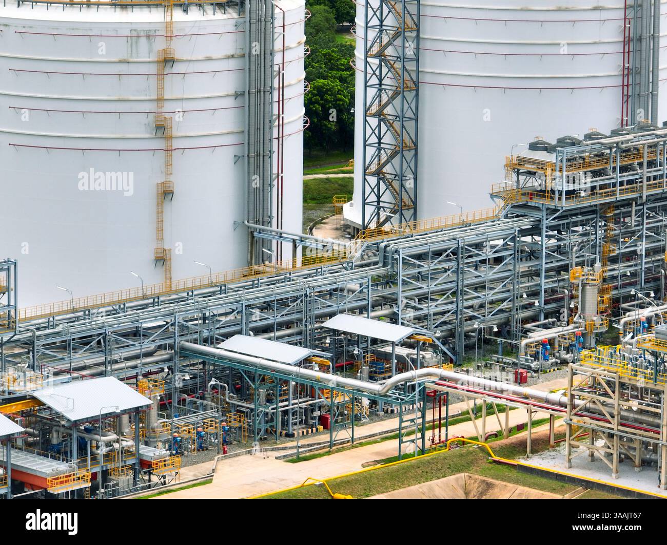 Industrial oil refinery with complex network of steel pipelines and ...