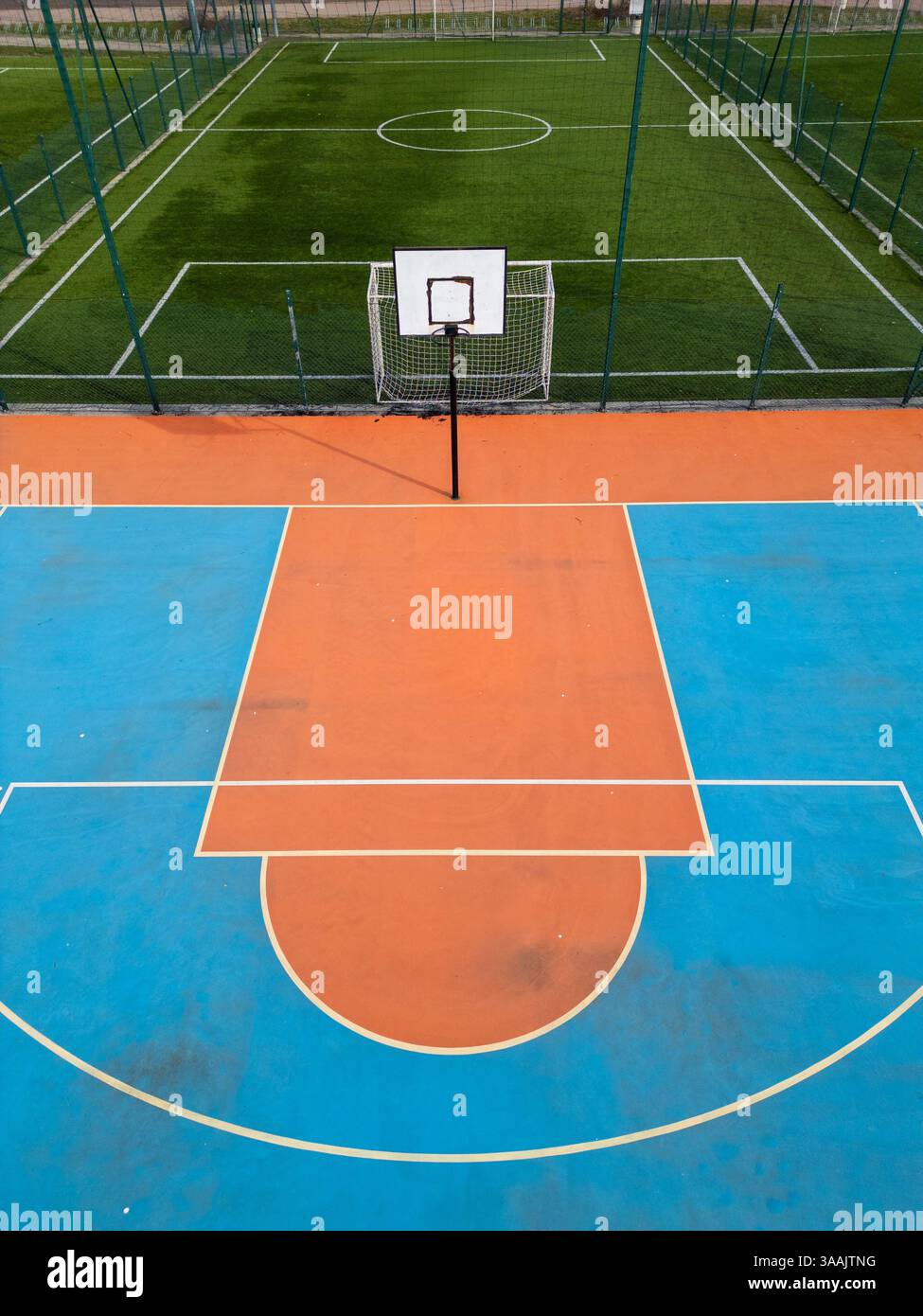 Aerial view of outdoor basketball and soccer courts with vibrant blue ...