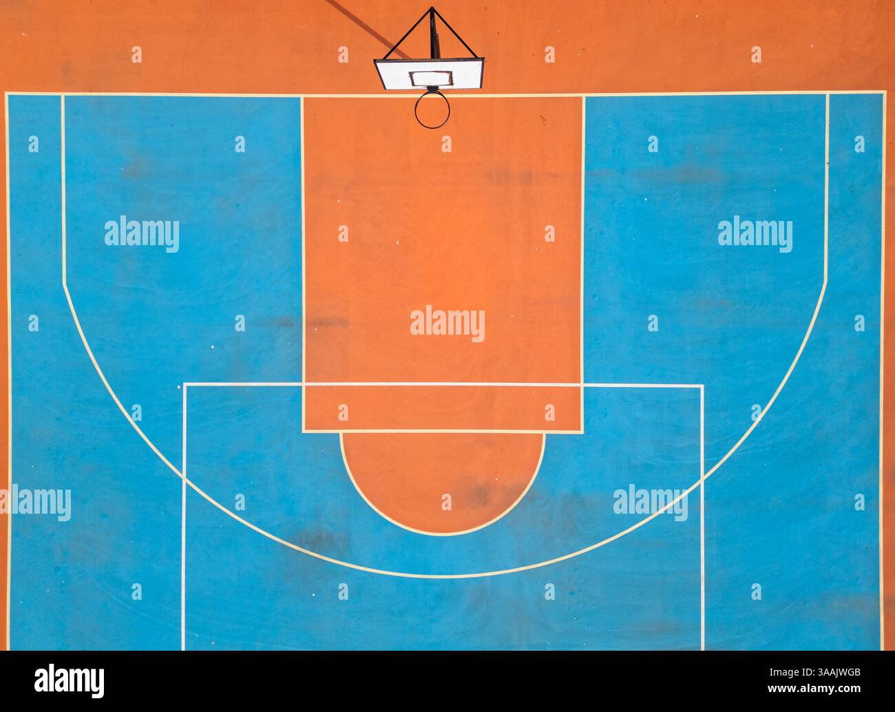 Aerial view of a basketball hoop and colorful court with vibrant orange ...