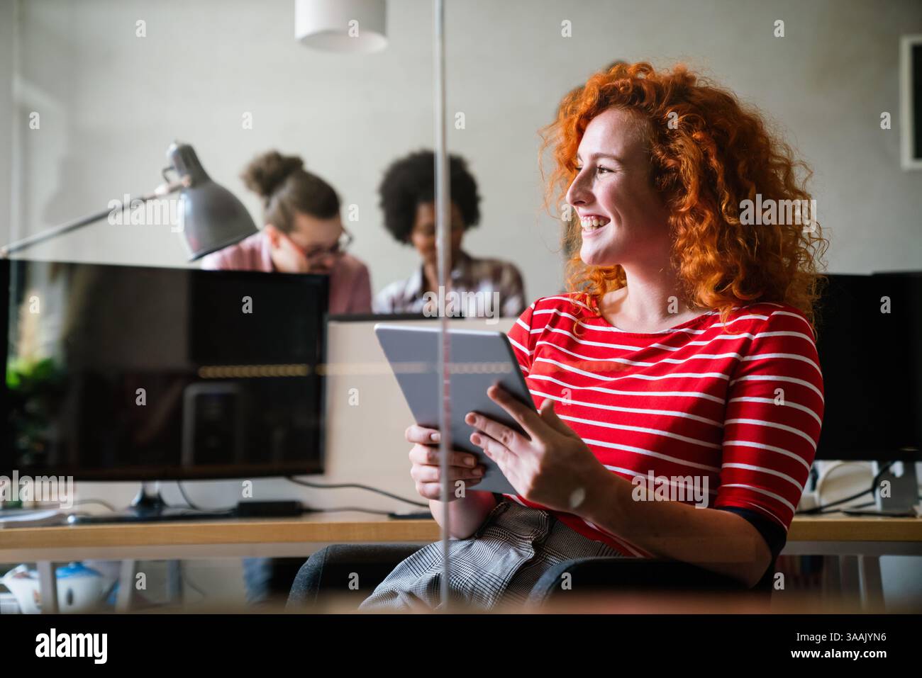 Portrait of young happy success woman working in a busy modern ...