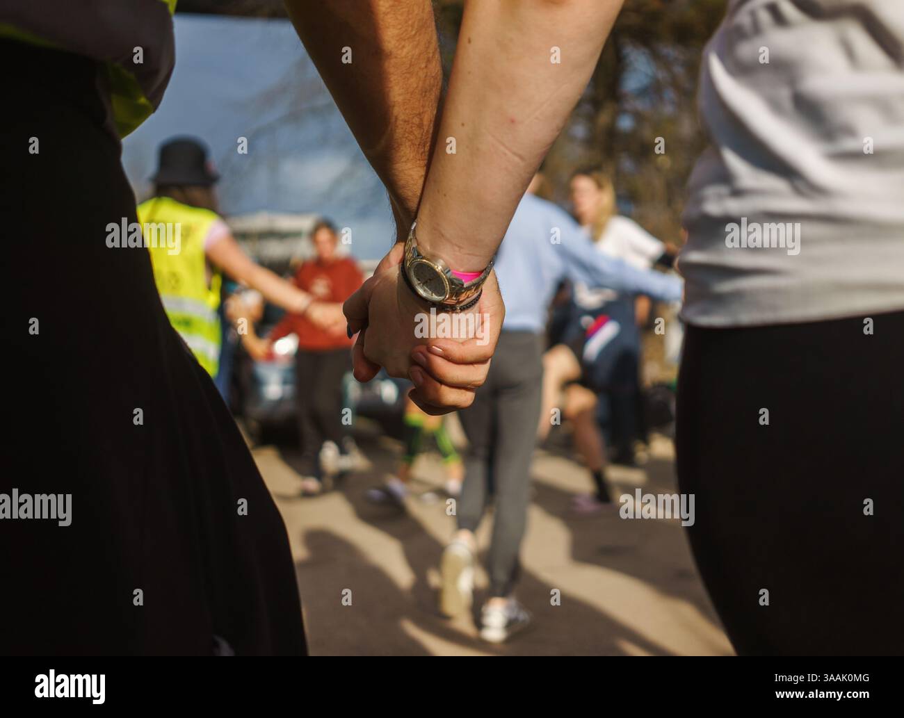 A man and a woman hold hands, dance in the Serbian kolo, a traditional ...