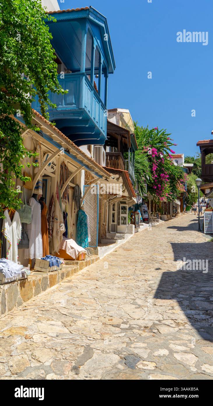 Shops and mediterranean style house with wooden balcony surrounded by ...
