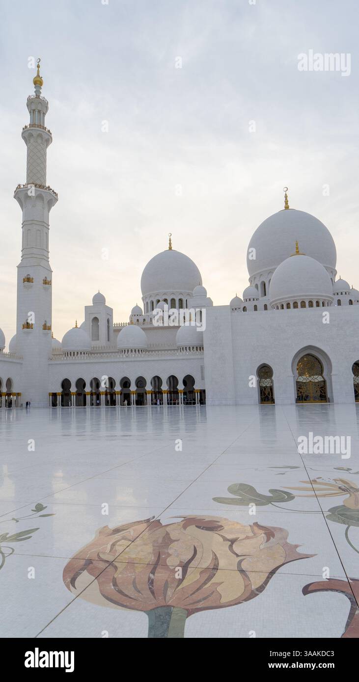 Mosaic of multicolored stone in form of flower on white marble floor of ...