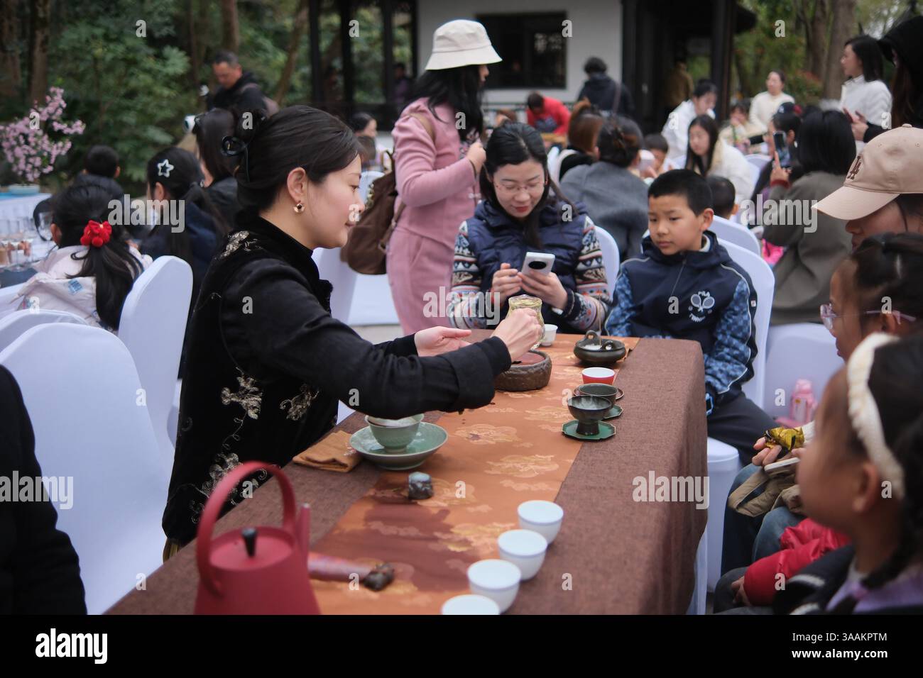 People experience picking tea leaves at a tea garden in Nantong City ...