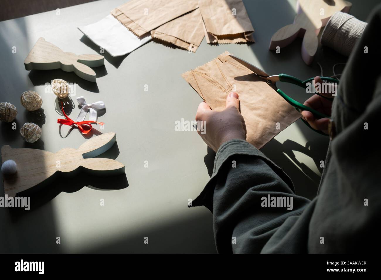 DIY process of woman making candid Easter present paper bag bunny ...