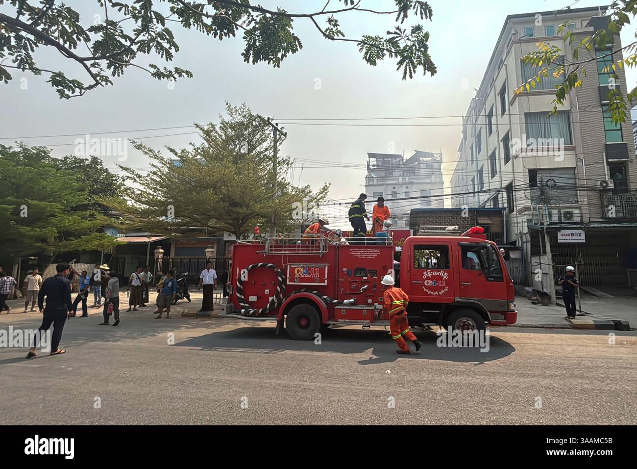 Firefighters attempt to distinguish a fire at a house in the aftermath ...