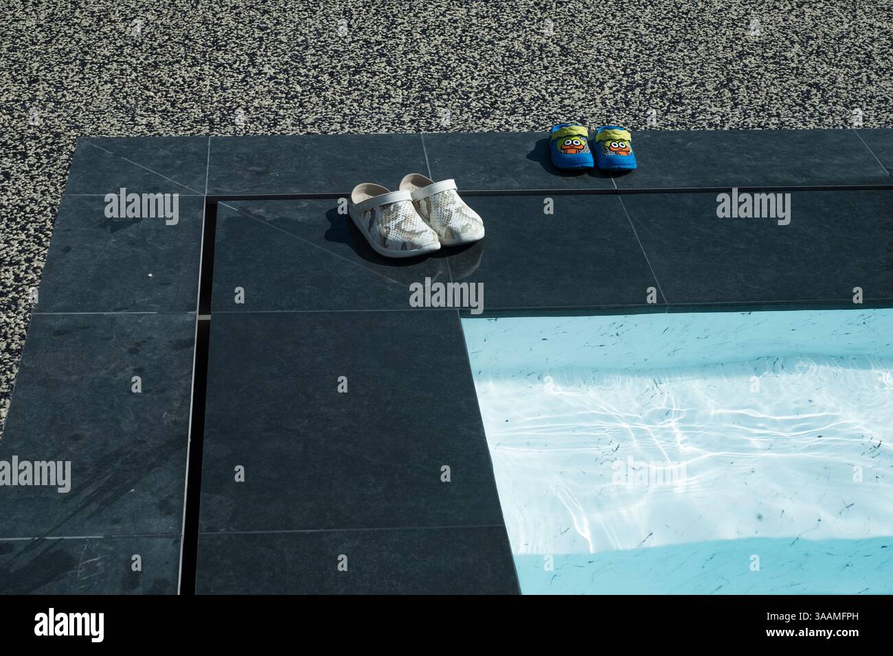 Rubber slippers near swimming pool Stock Photo - Alamy