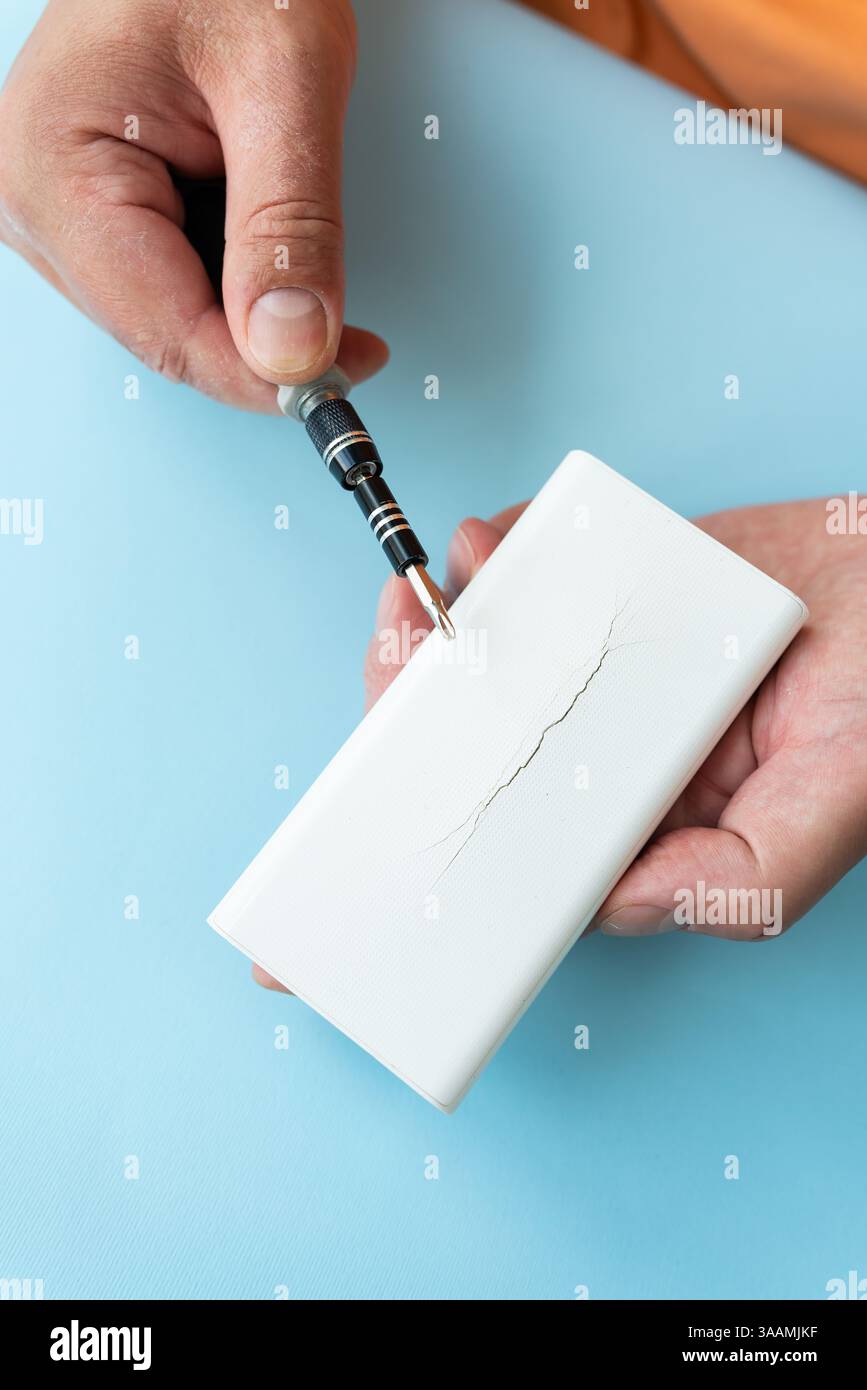 Person uses small screwdriver hi-res stock photography and images - Alamy