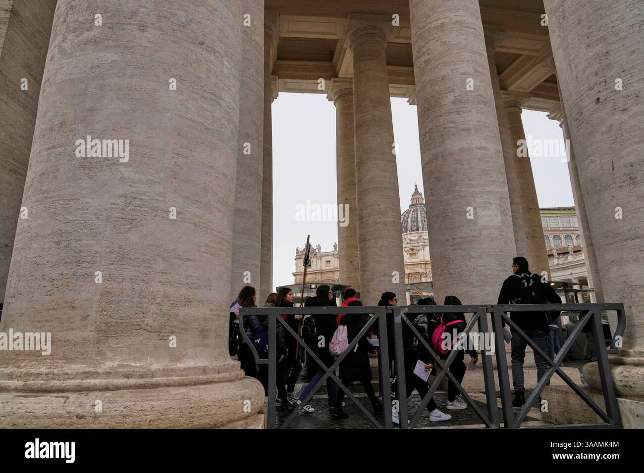 Pilgrims make their way through security checks to reach St. Peter's ...